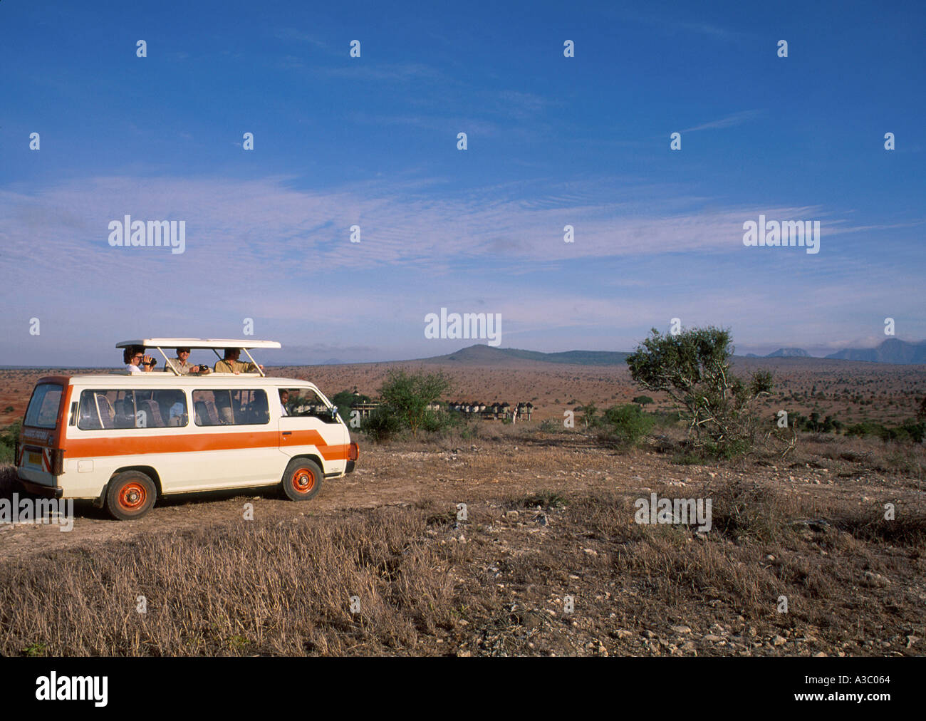 Kenya Safari w tourists in minivan Stock Photo - Alamy