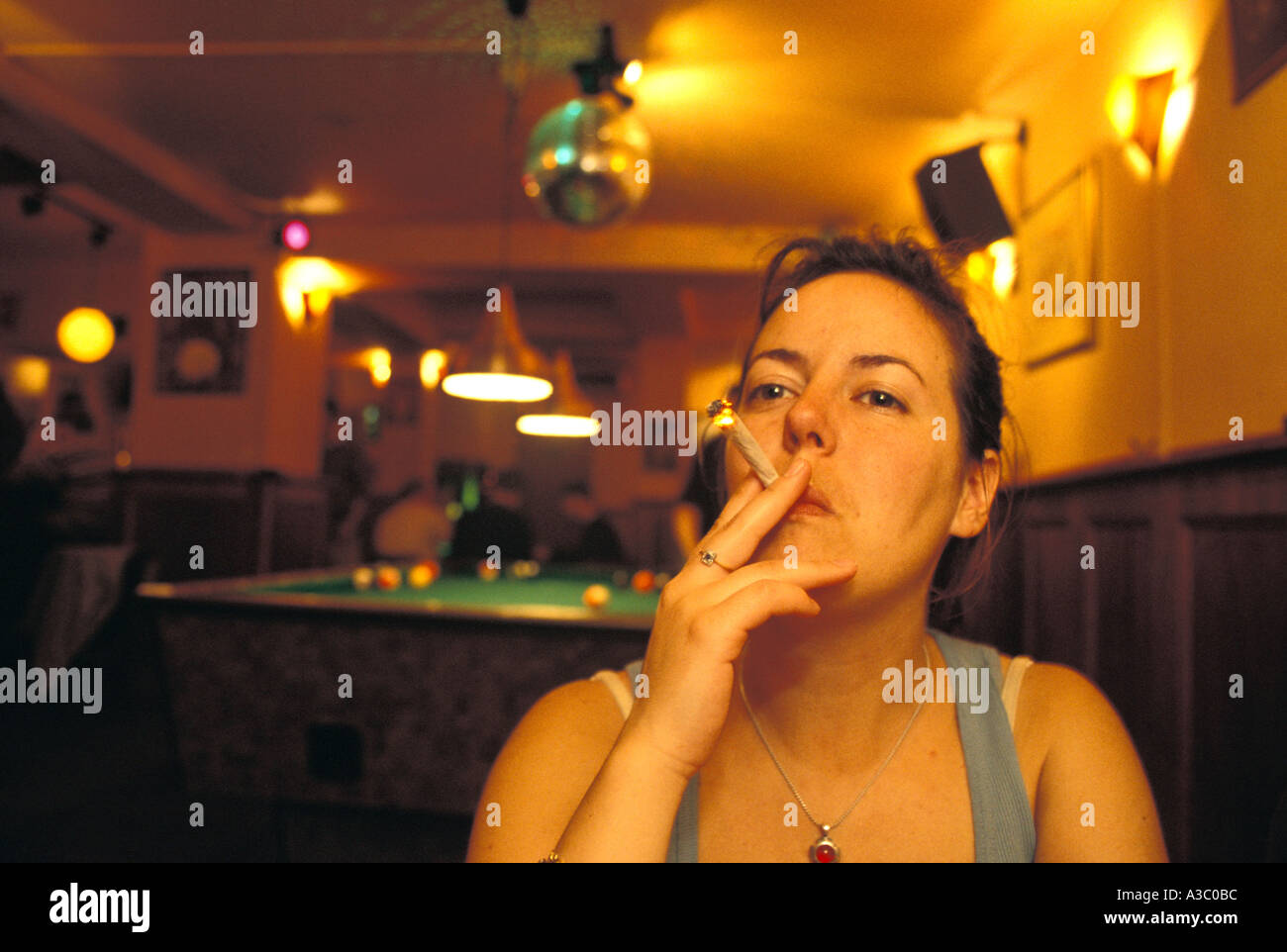 Woman smoking cannabis joint in Coffeeshop in Amsterdam Stock Photo - Alamy