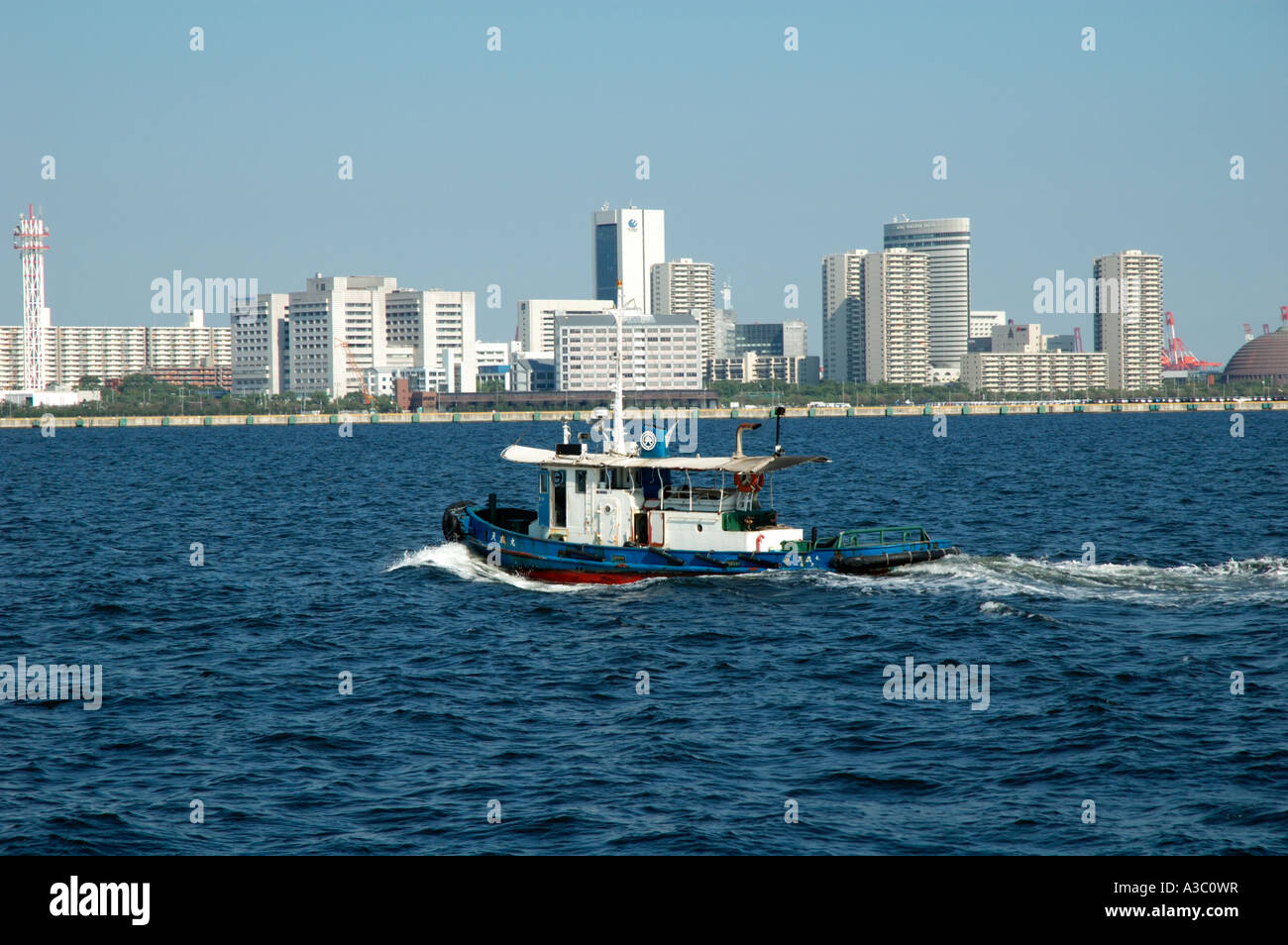 Small ship entering Kobe harbour Stock Photo - Alamy