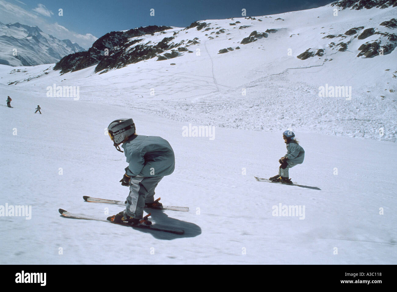 Kids racing on skis Stock Photo - Alamy