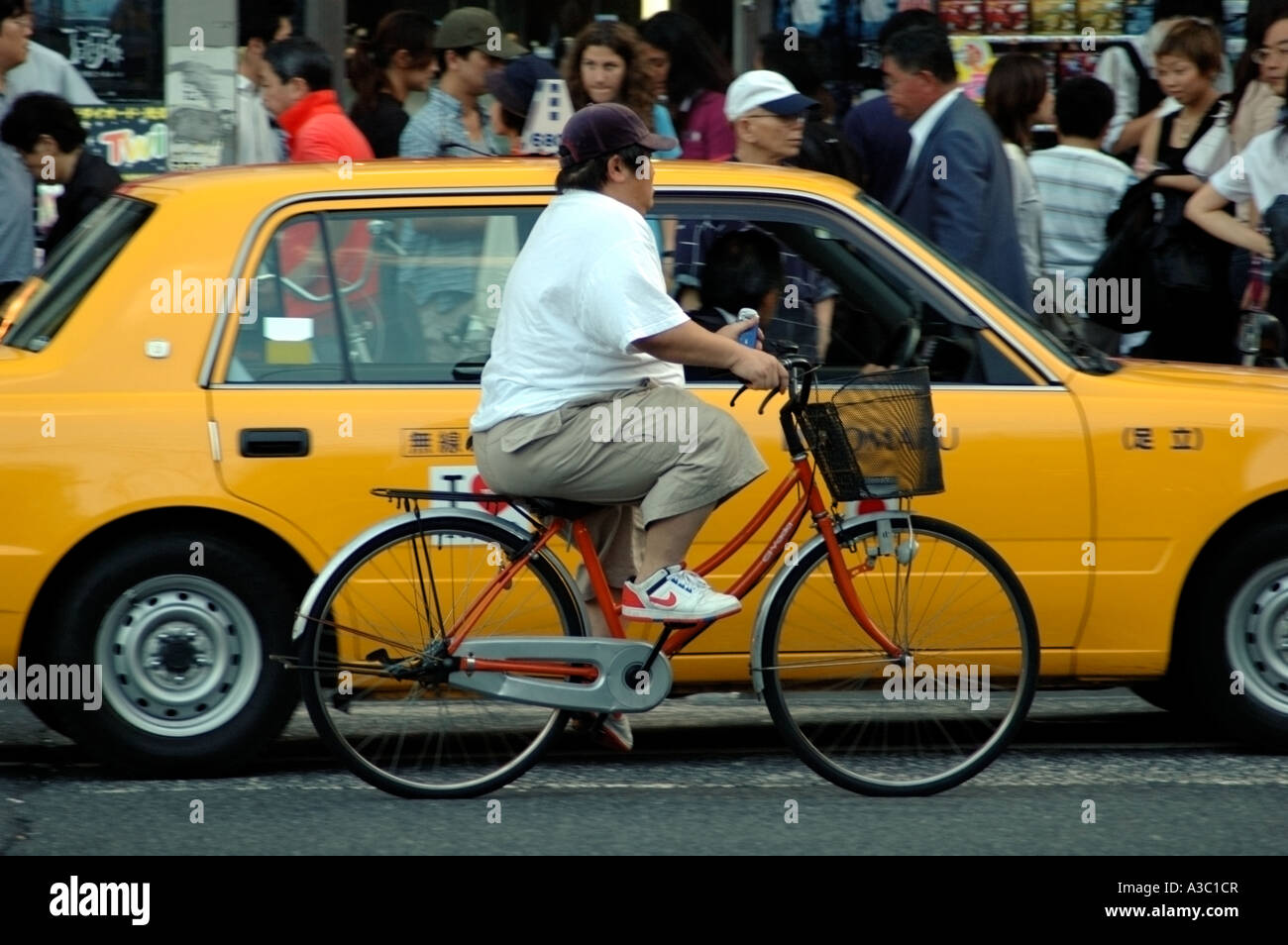 Street scene in Tokyo taxi and bicycle Stock Photo - Alamy