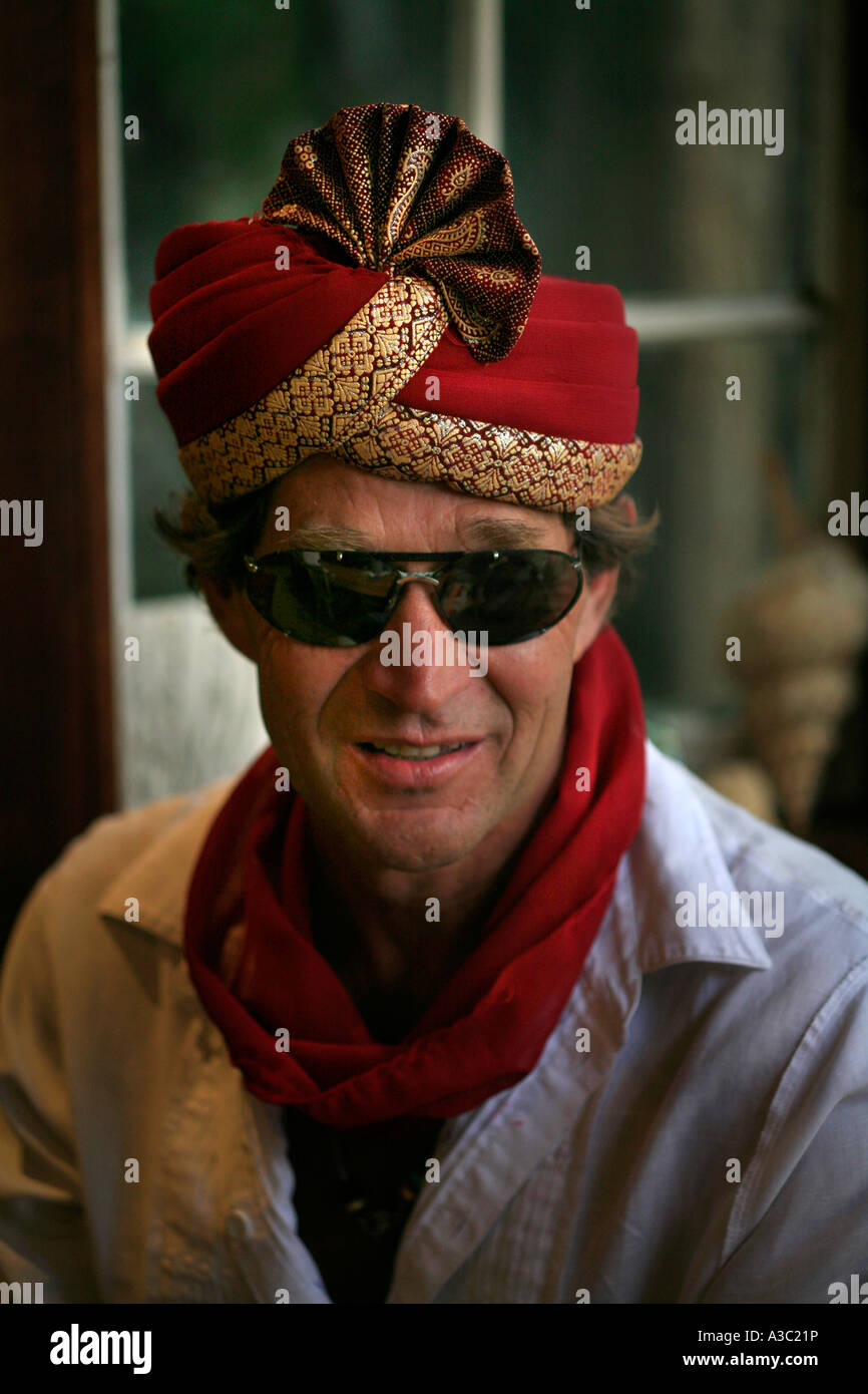 A European man wears a colourful and highly decorated Indian headdress ...