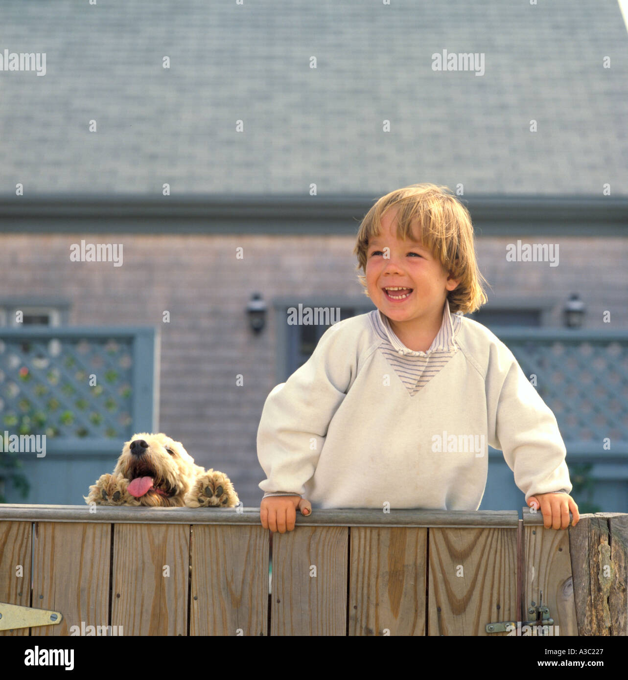 Boy leaning over fence High Resolution Stock Photography and Images - Alamy
