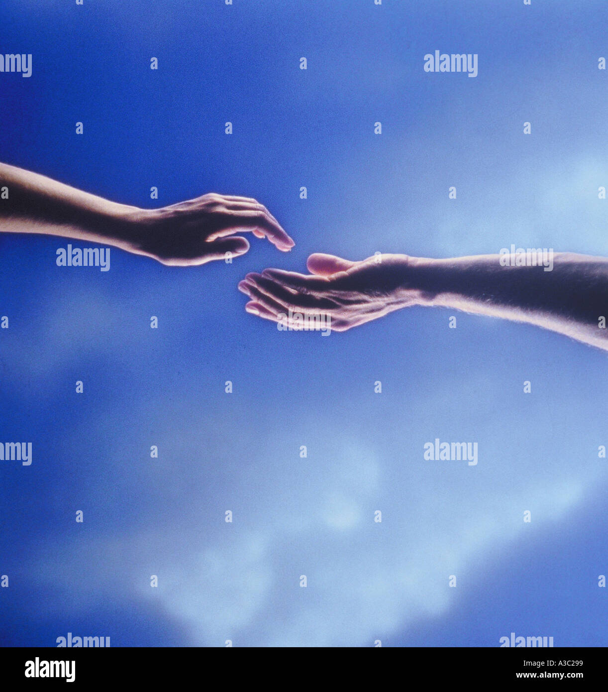 A pair of arms reaching out to each other with clouds in the background ...