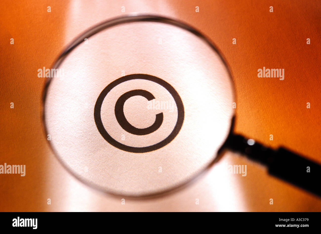 Copywright sign through a magnifying glass Stock Photo - Alamy
