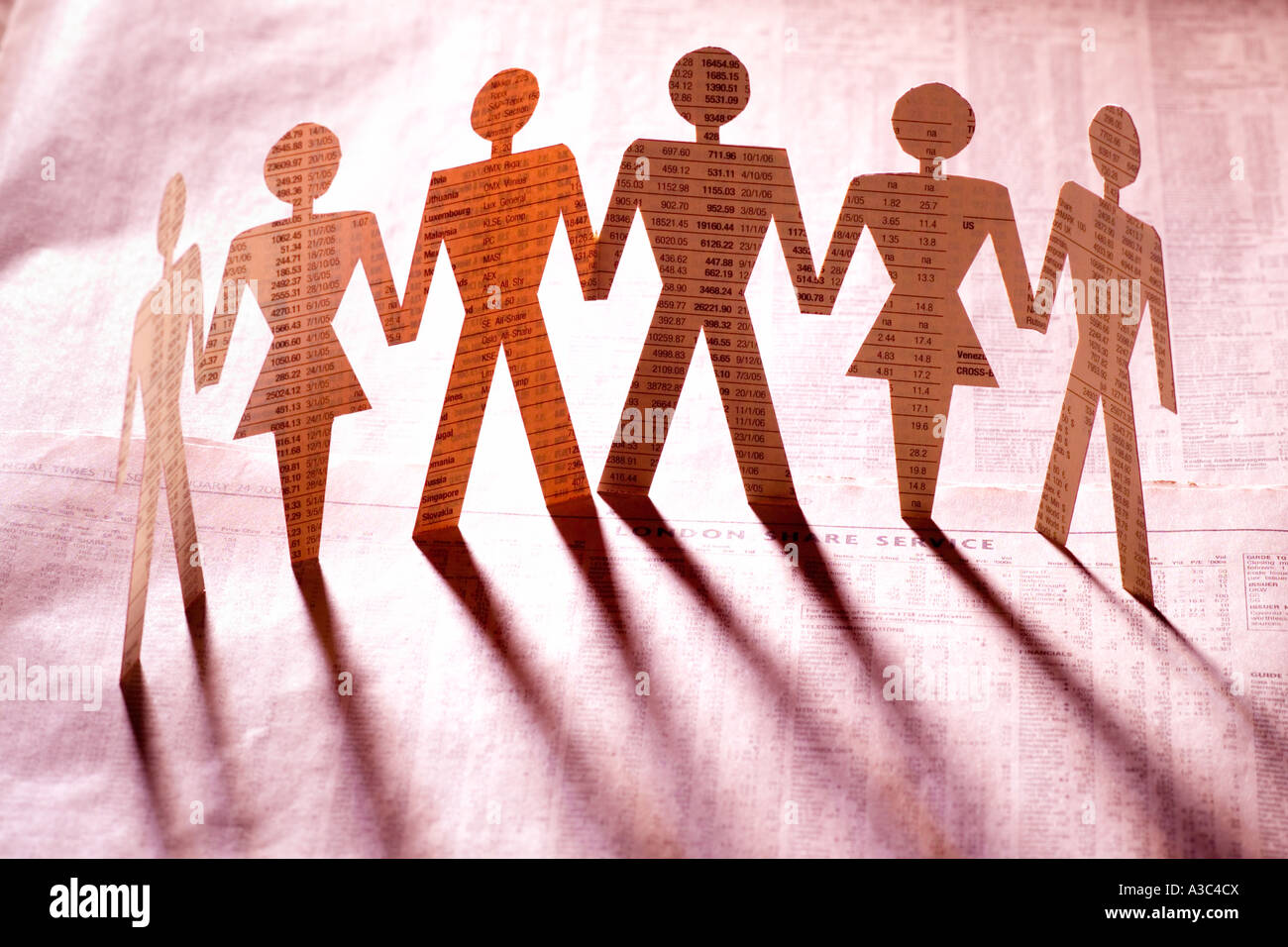 Financial Times Paper men and women cut outs in pink Stock Photo - Alamy