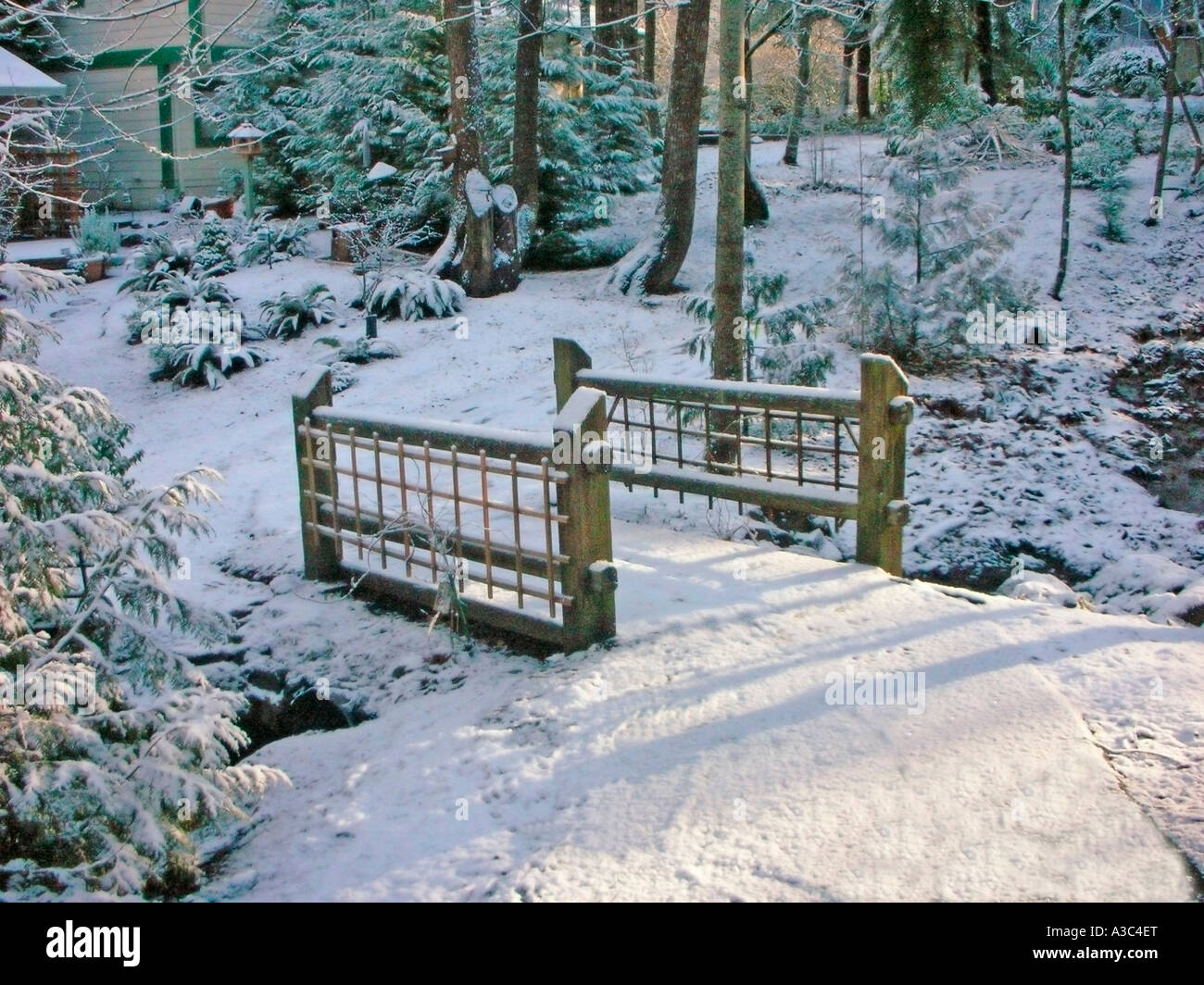 A snowy footbridge in a wooded residential community in Portland ...