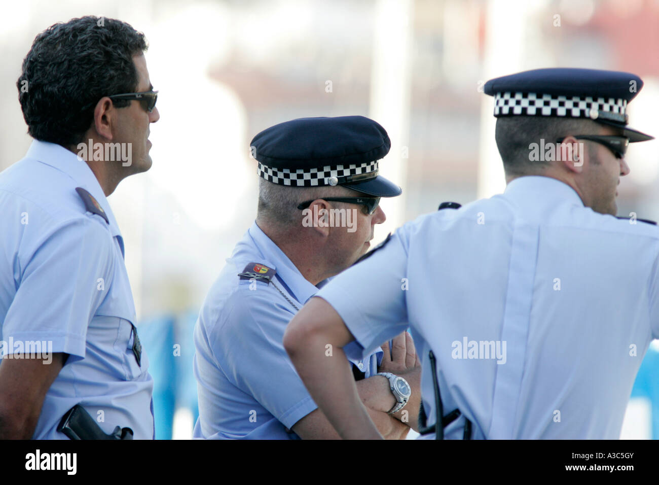 three spanish police officers watch illegal immigrants from north ...