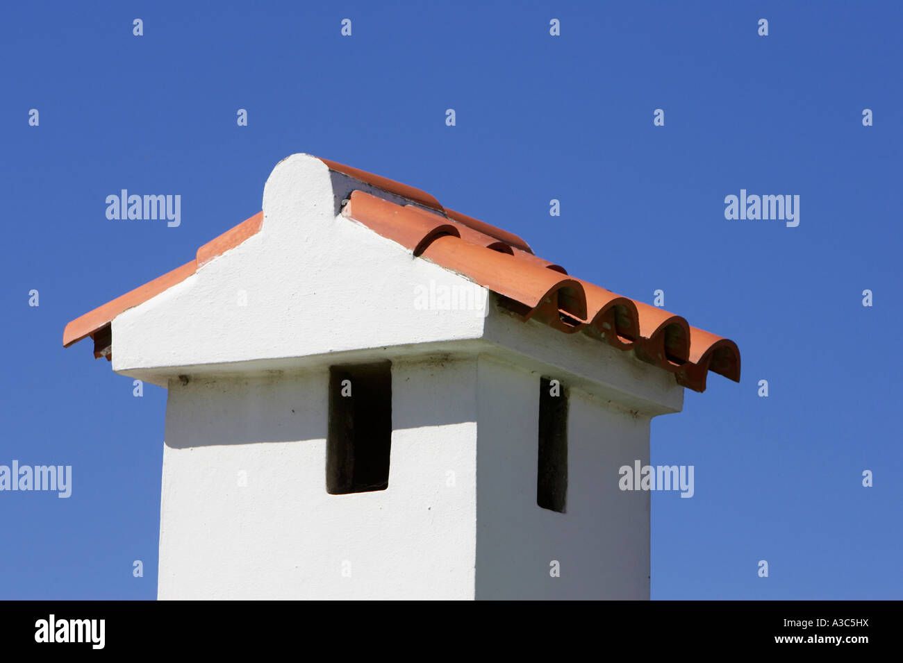 chimney stack of a modern house tiled with traditional new terracotta ...