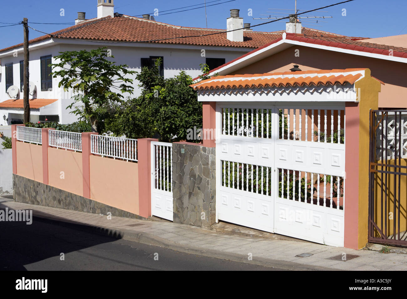 traditional house with tile roof and security metal wrought iron gates ...