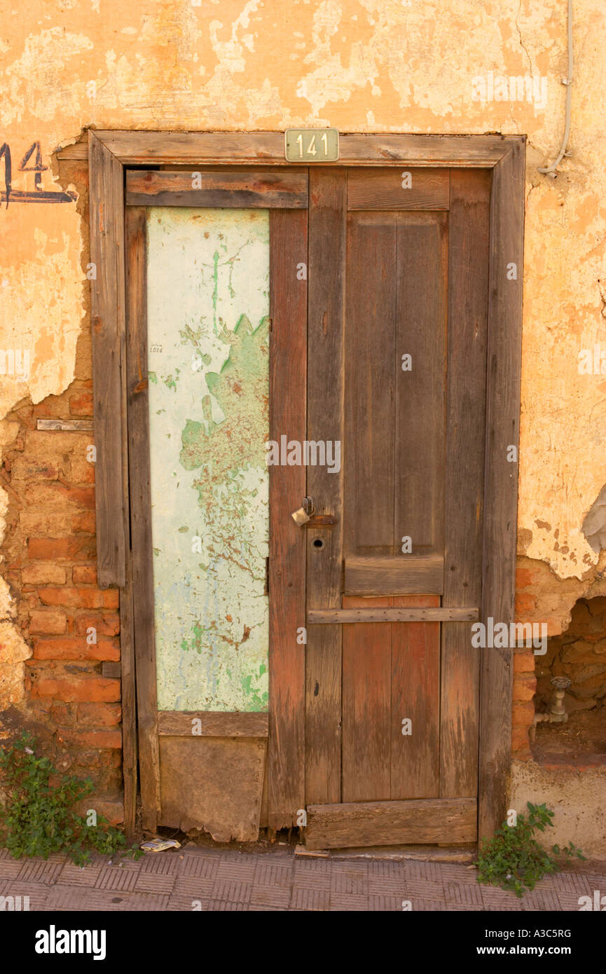 number 141 old weathered brown wooden door entrance to abandoned house ...