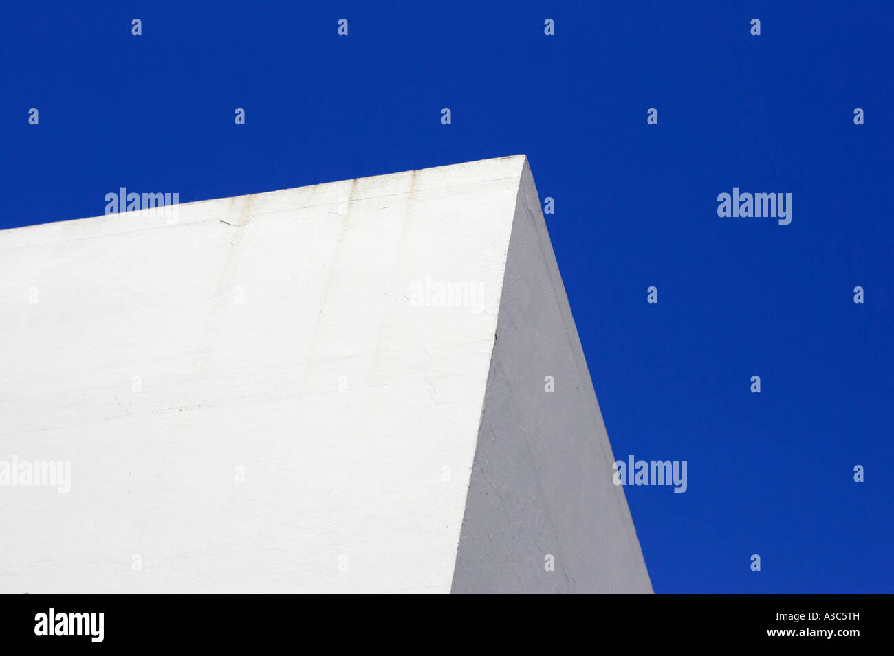 angular corner of traditonal flat roofed white washed spanish home ...