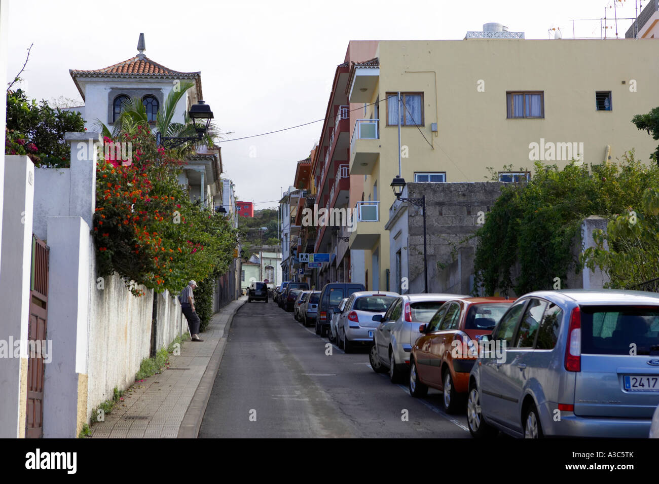cars parked in a narrow steep uphill street in Tacoronte Tenerife ...