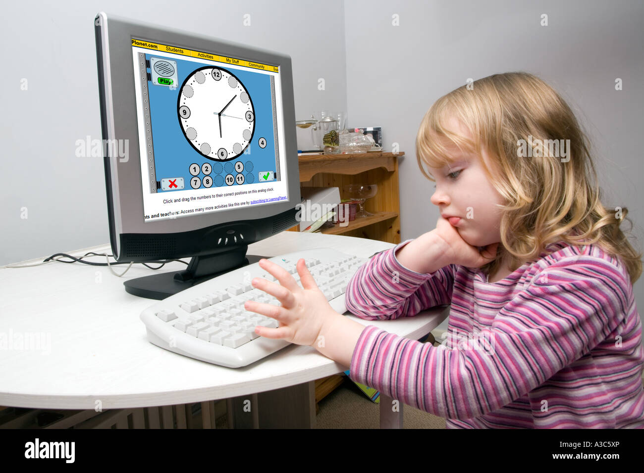 young child playing time program on a computer Stock Photo - Alamy