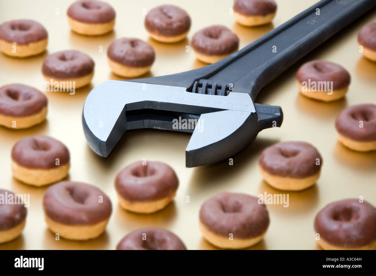Adjustable Spanner with ring chocolate doughnuts Stock Photo - Alamy
