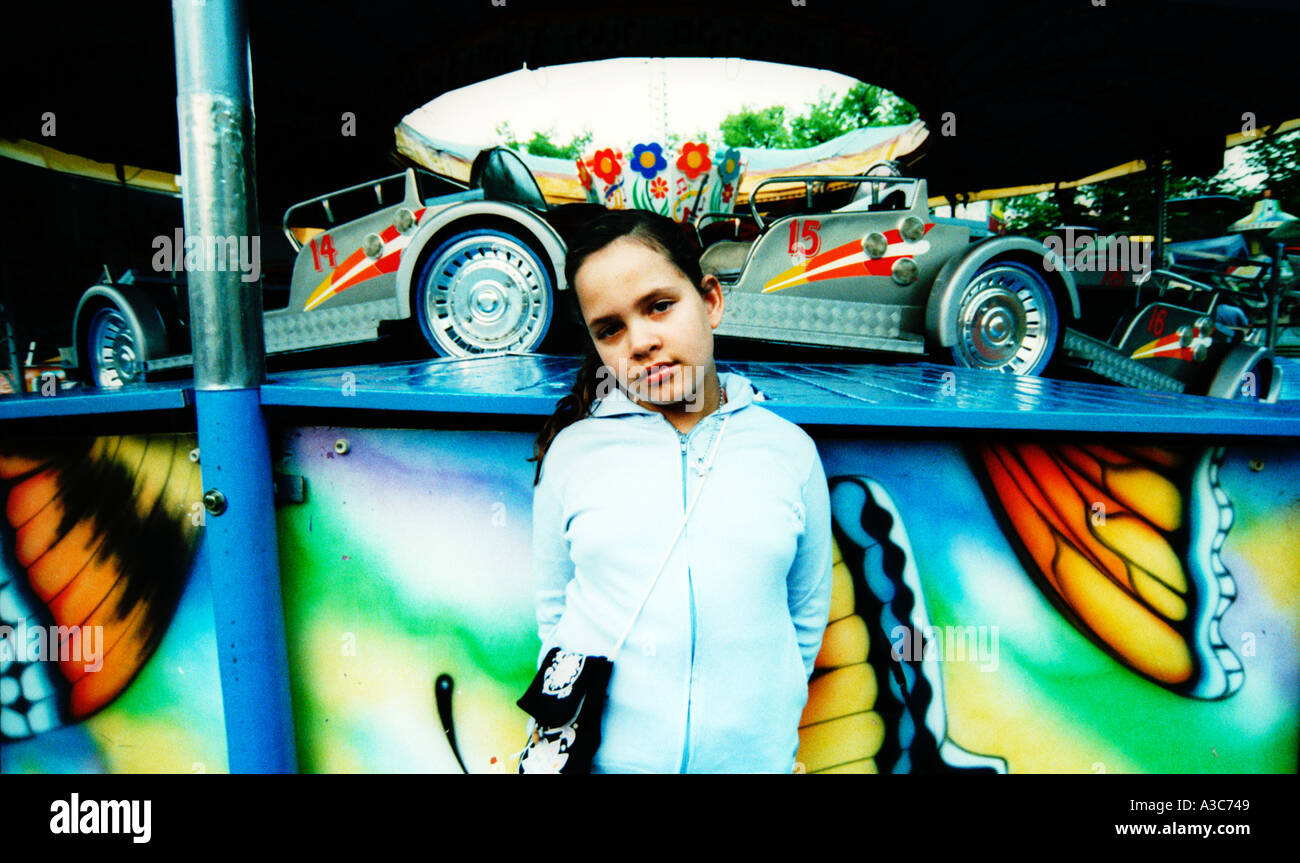teenage girl leaning against a roundabout ride Stock Photo - Alamy