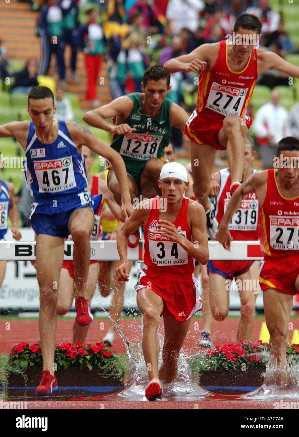 runners jumping the obstacle of a 300m race at the Munich European ...