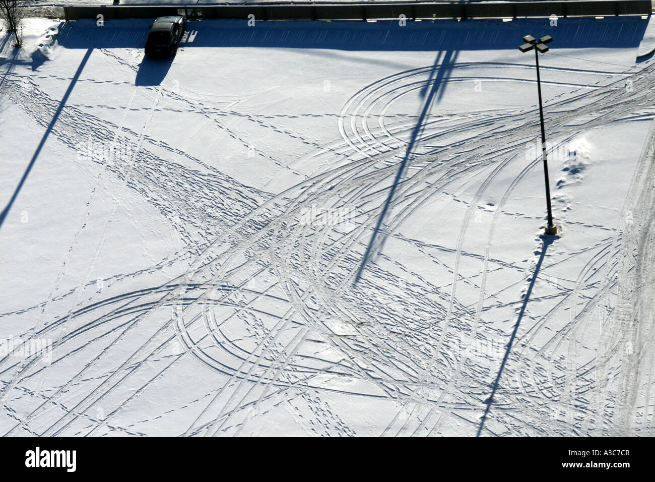 Car tracks in the snow in a parking lot. View from above Stock Photo ...