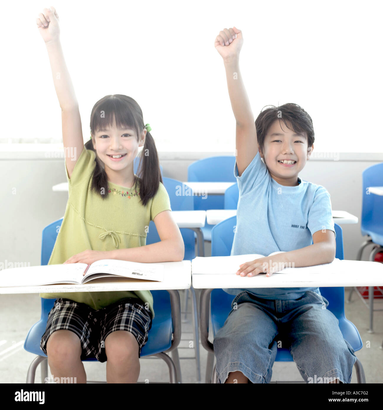 Two children raising their hands Stock Photo - Alamy