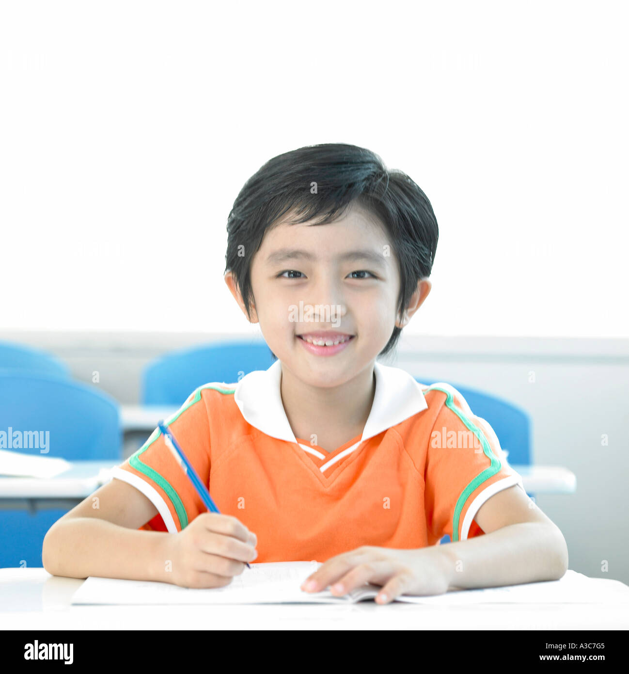 A boy smiling on the desk Stock Photo - Alamy