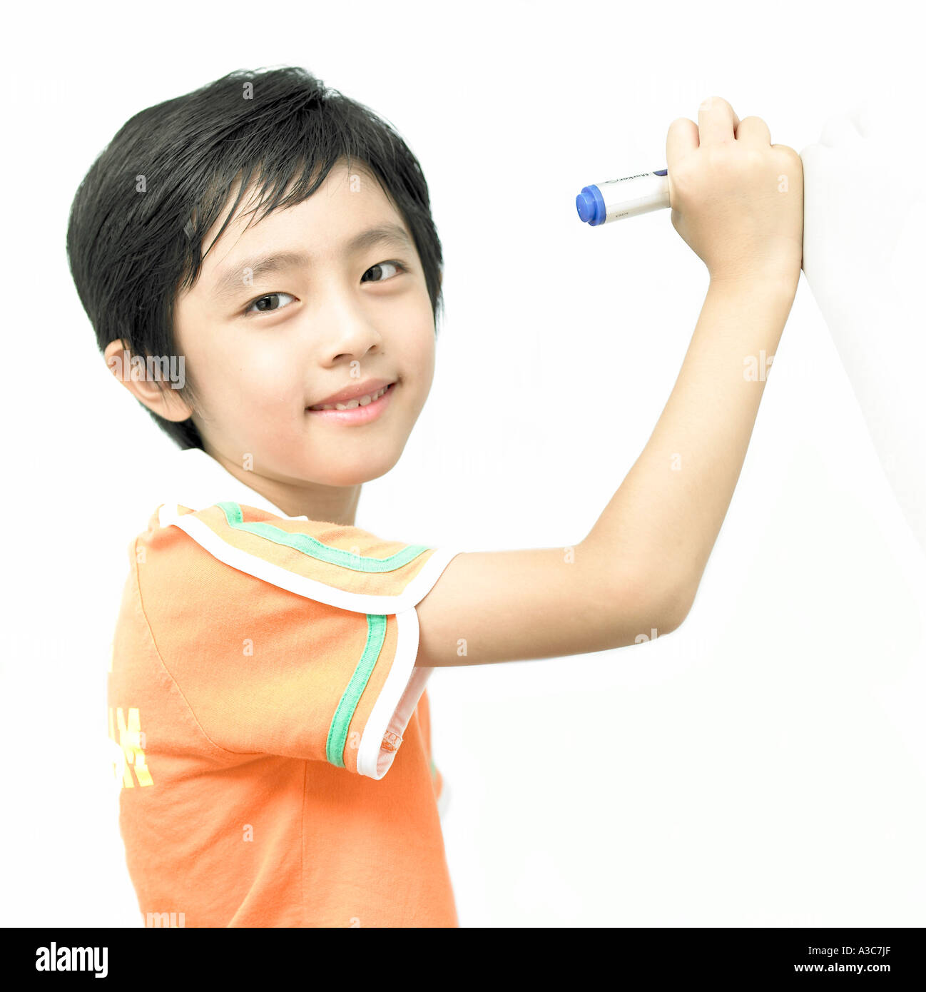 A boy writing on the whiteboard Stock Photo - Alamy