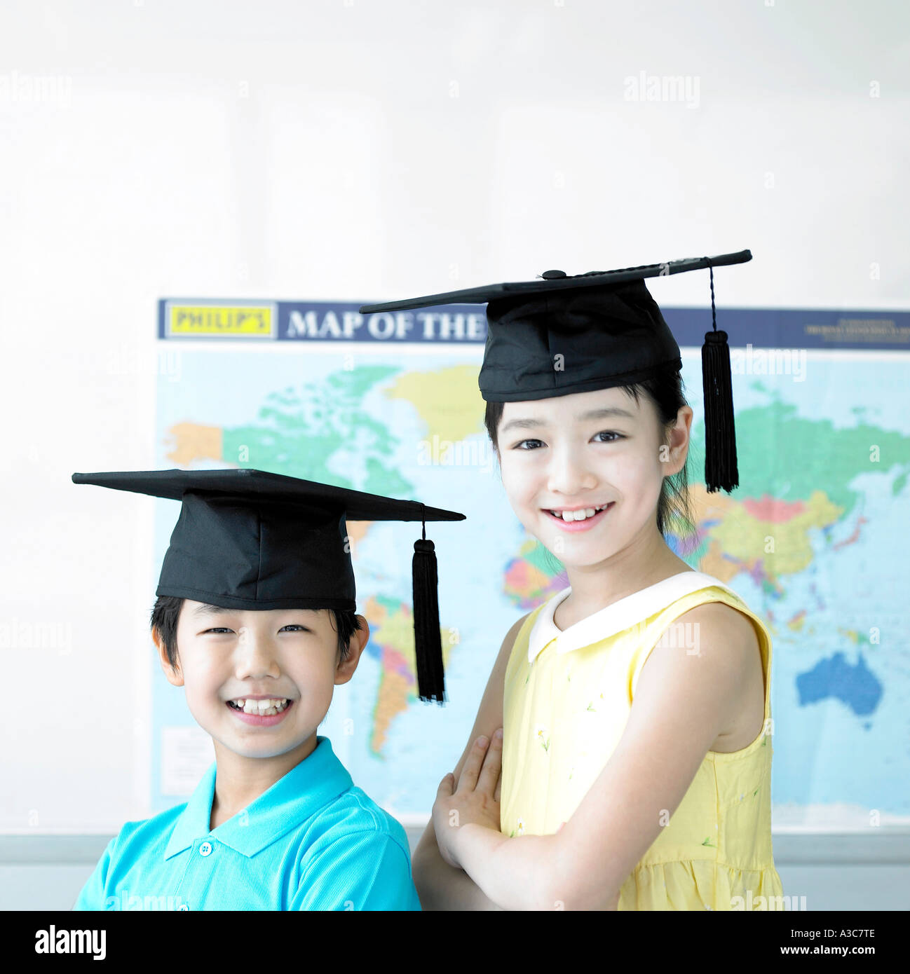 A boy and girl wearing graduation caps Stock Photo - Alamy