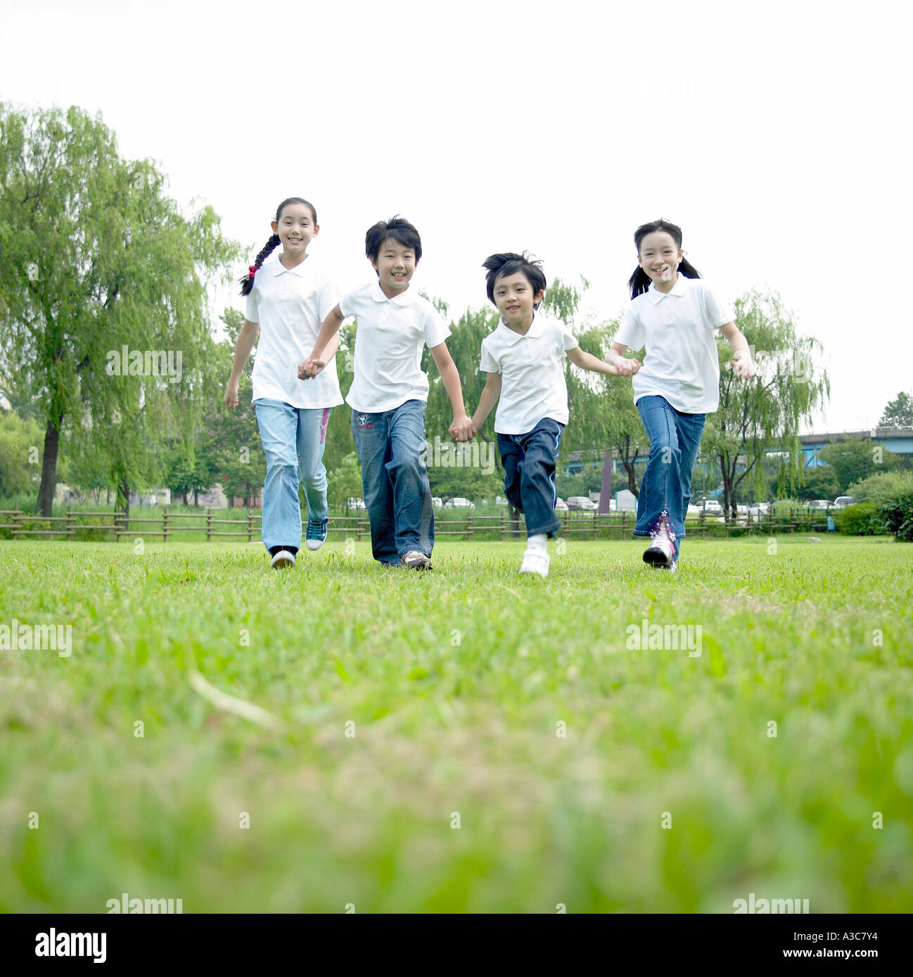 Children running forward on grass Stock Photo - Alamy