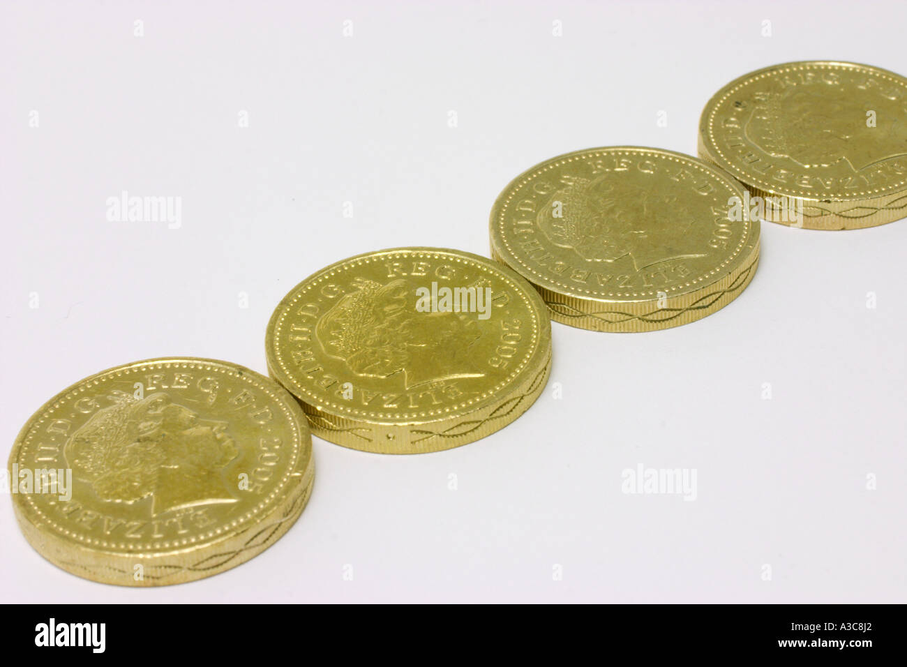 Line of four British pound coins Stock Photo - Alamy