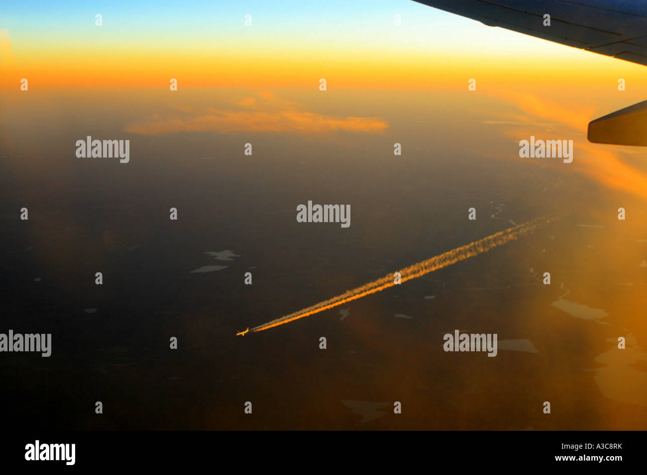 View from the airplane window at sunset with part of the wing visible ...