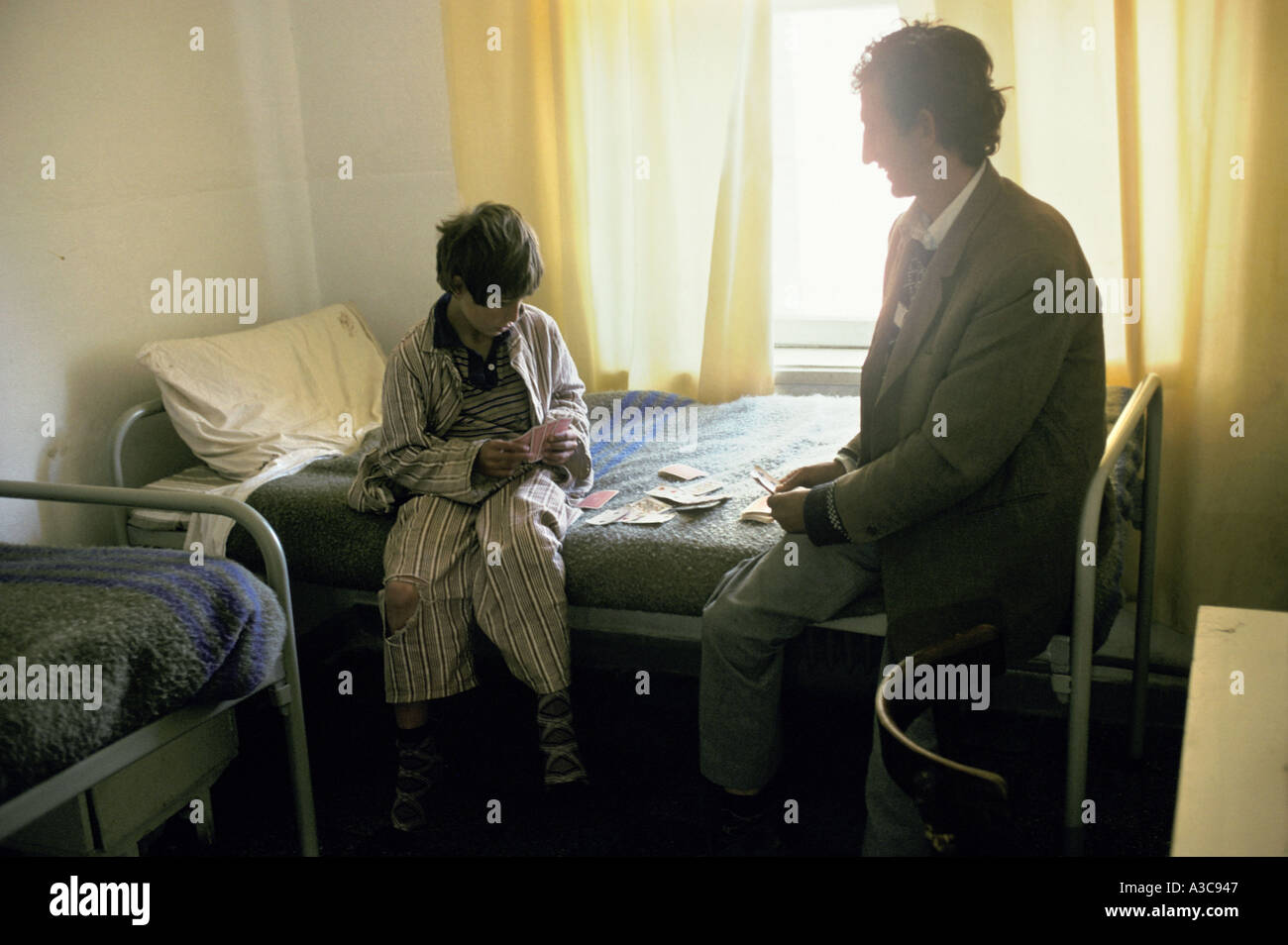 Father and son playing cards on hospital bed, Tepelene, Albania Stock ...