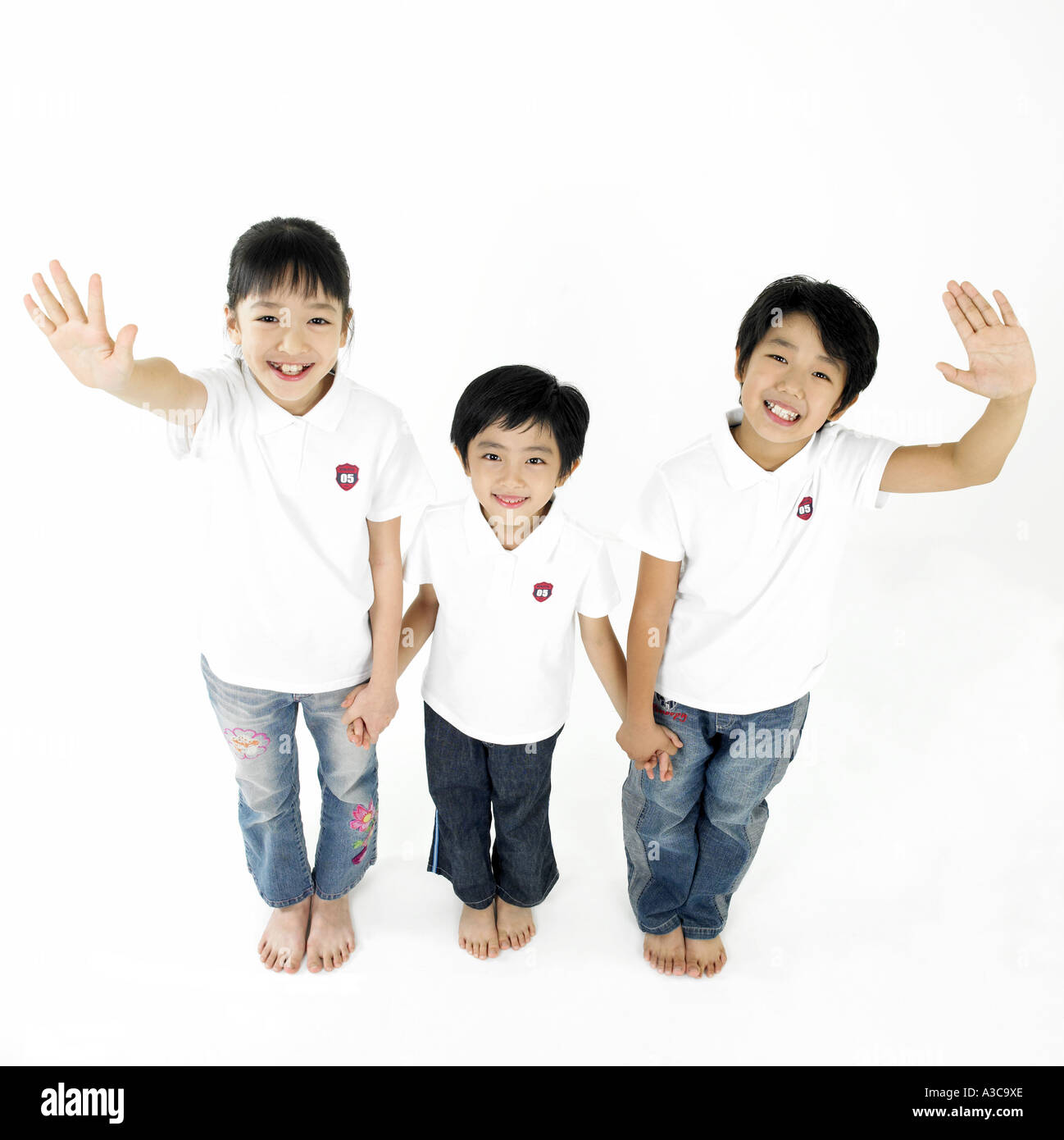 Three children saying hello Stock Photo - Alamy
