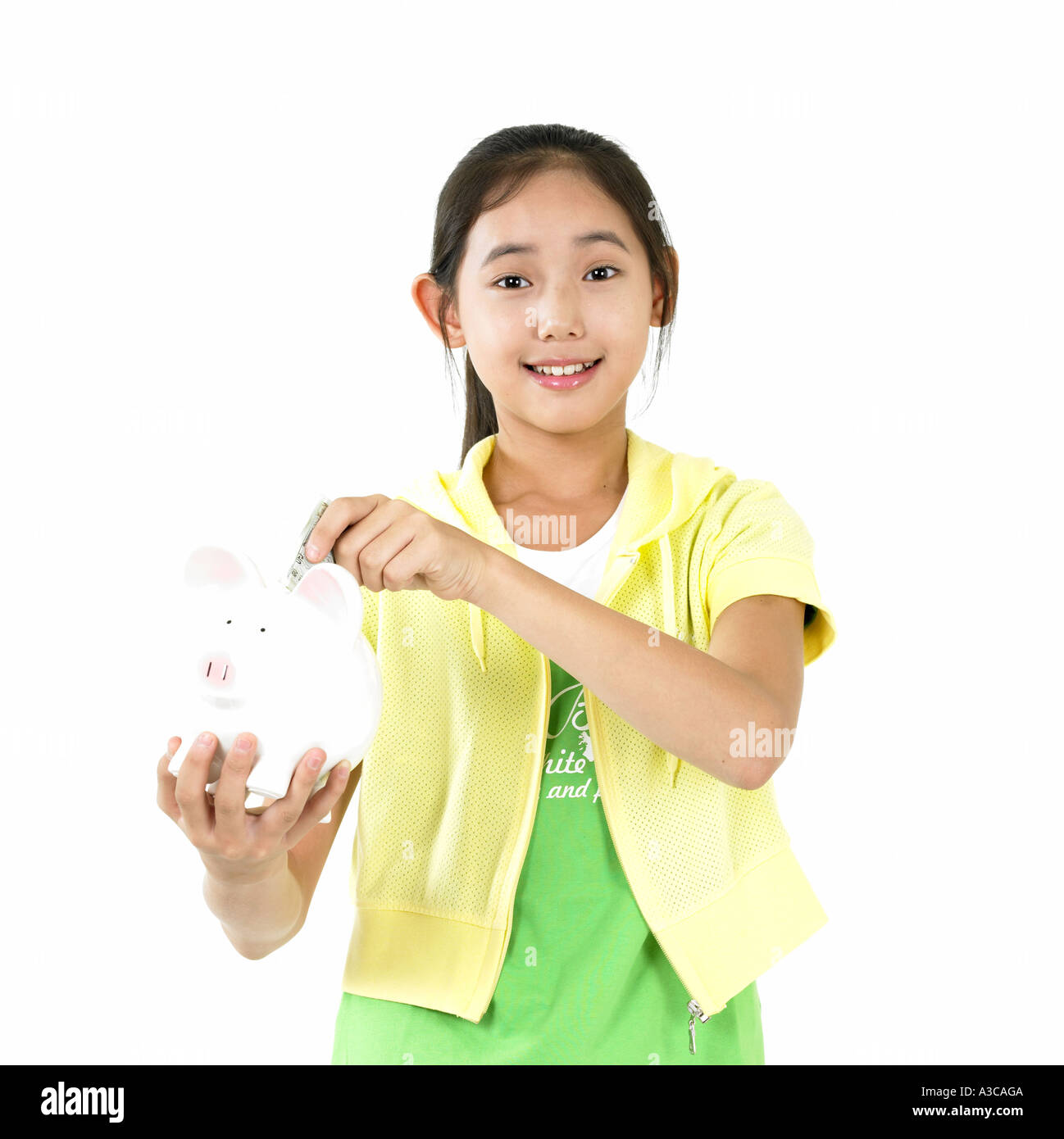 Girl putting coin in the saving box Stock Photo - Alamy