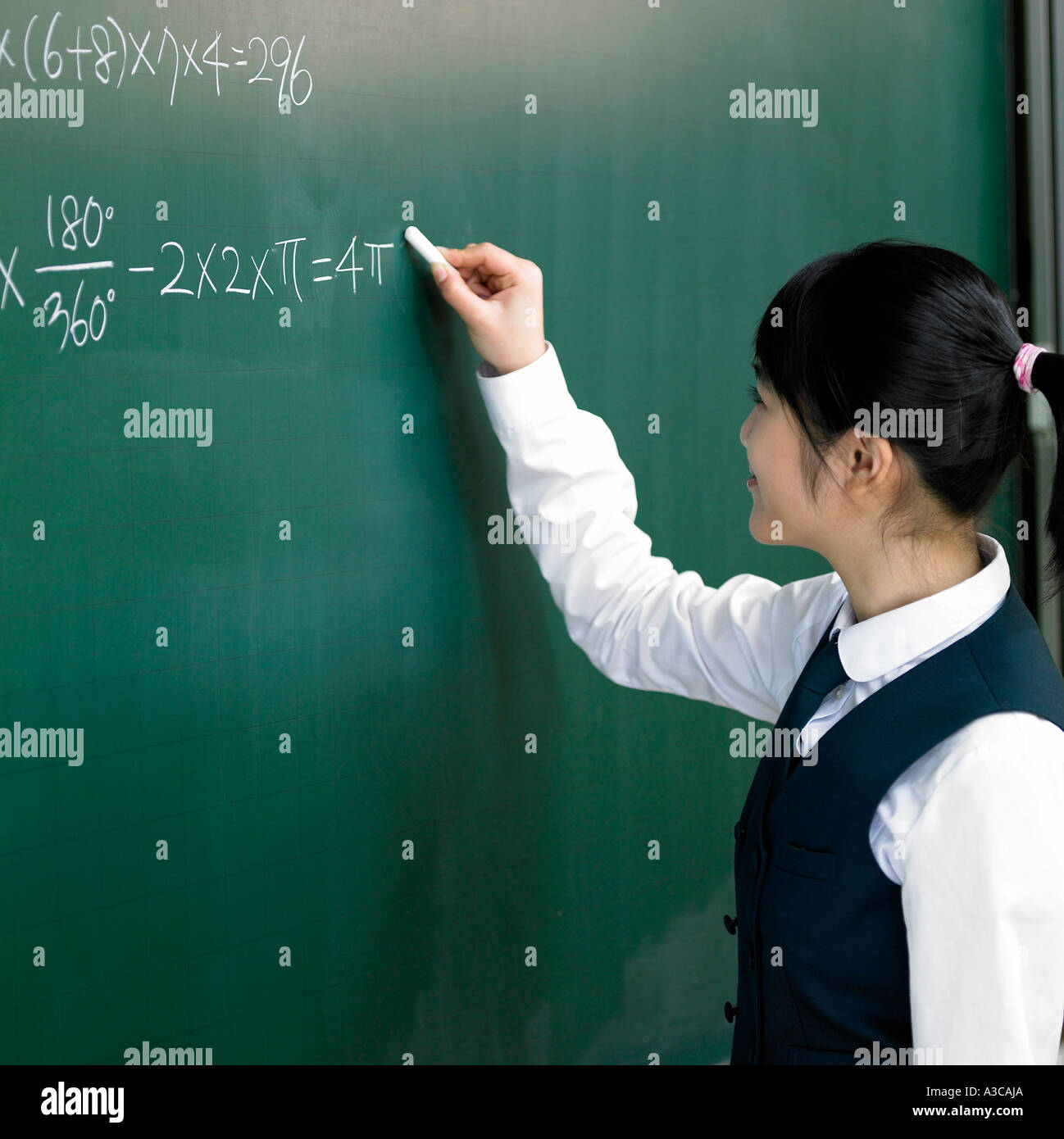 A student writing mathematical a formula on the blackboard Stock Photo ...