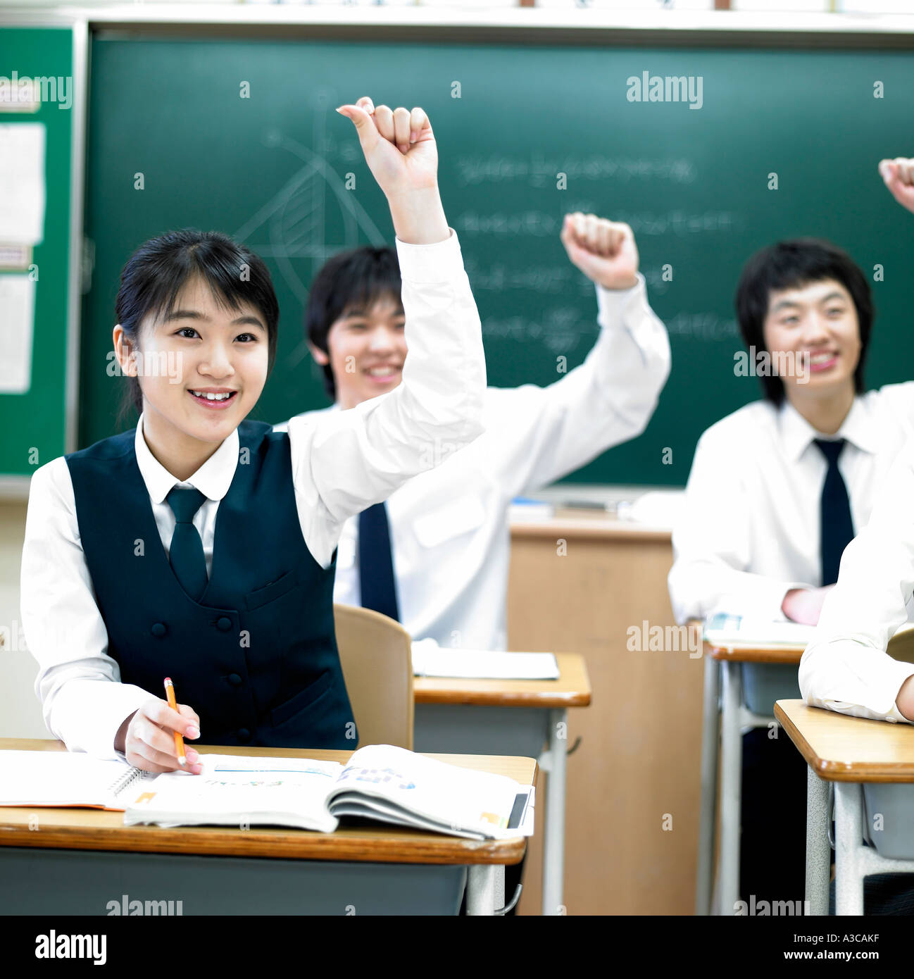 Students raising their hands Stock Photo - Alamy