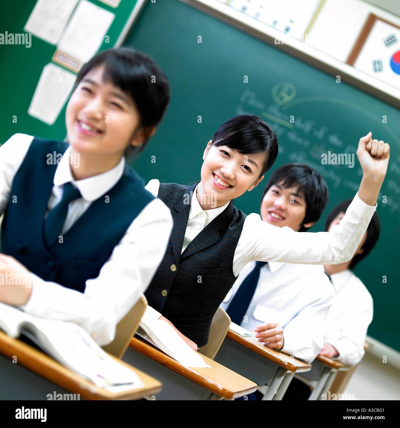 A student raising her hand Stock Photo - Alamy