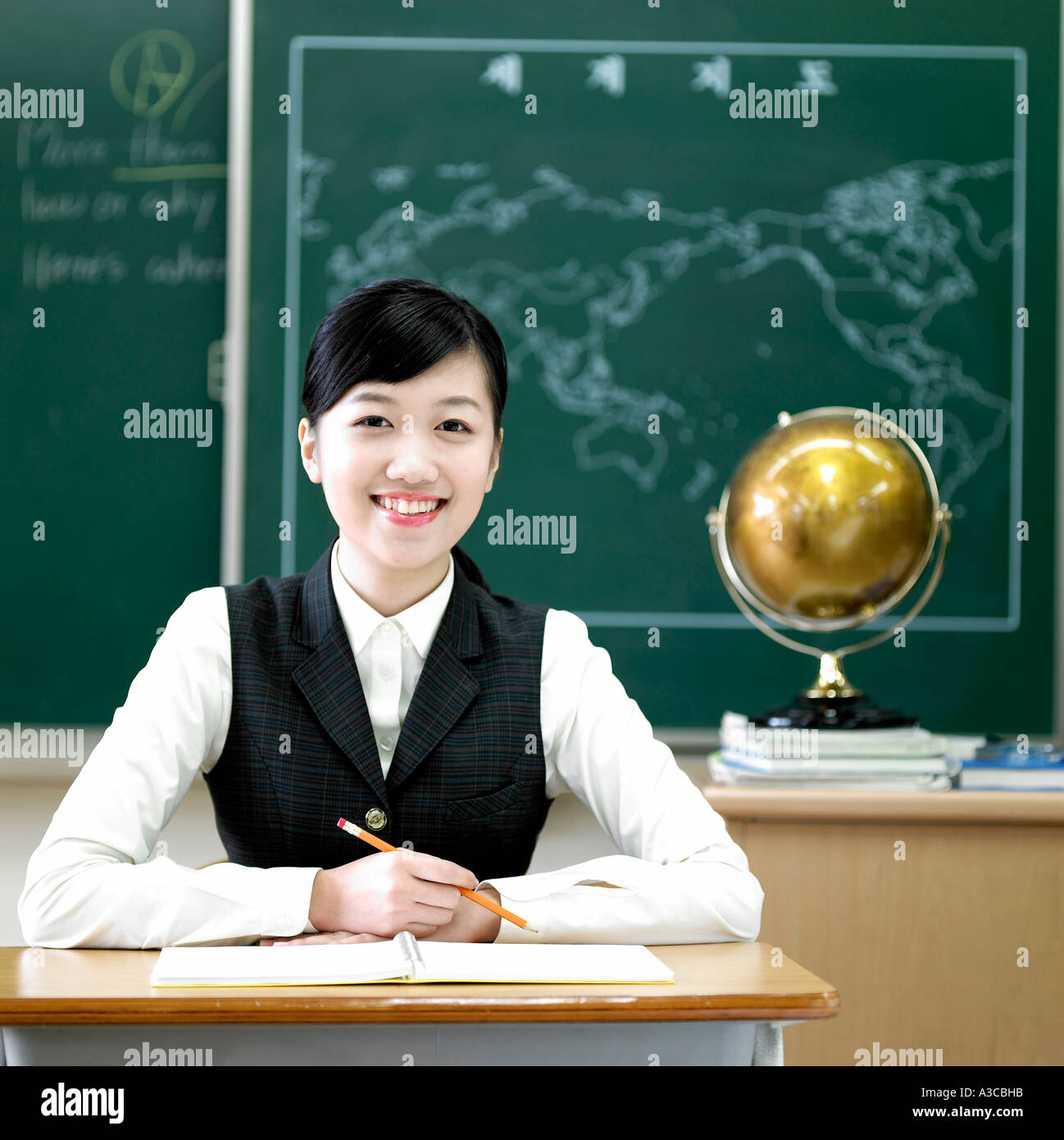 A student studing beside a globe Stock Photo - Alamy