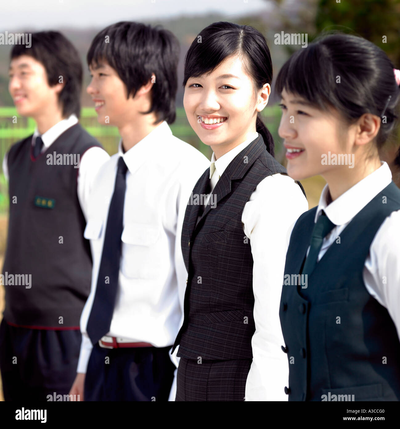 Students standing together on the school ground Stock Photo - Alamy