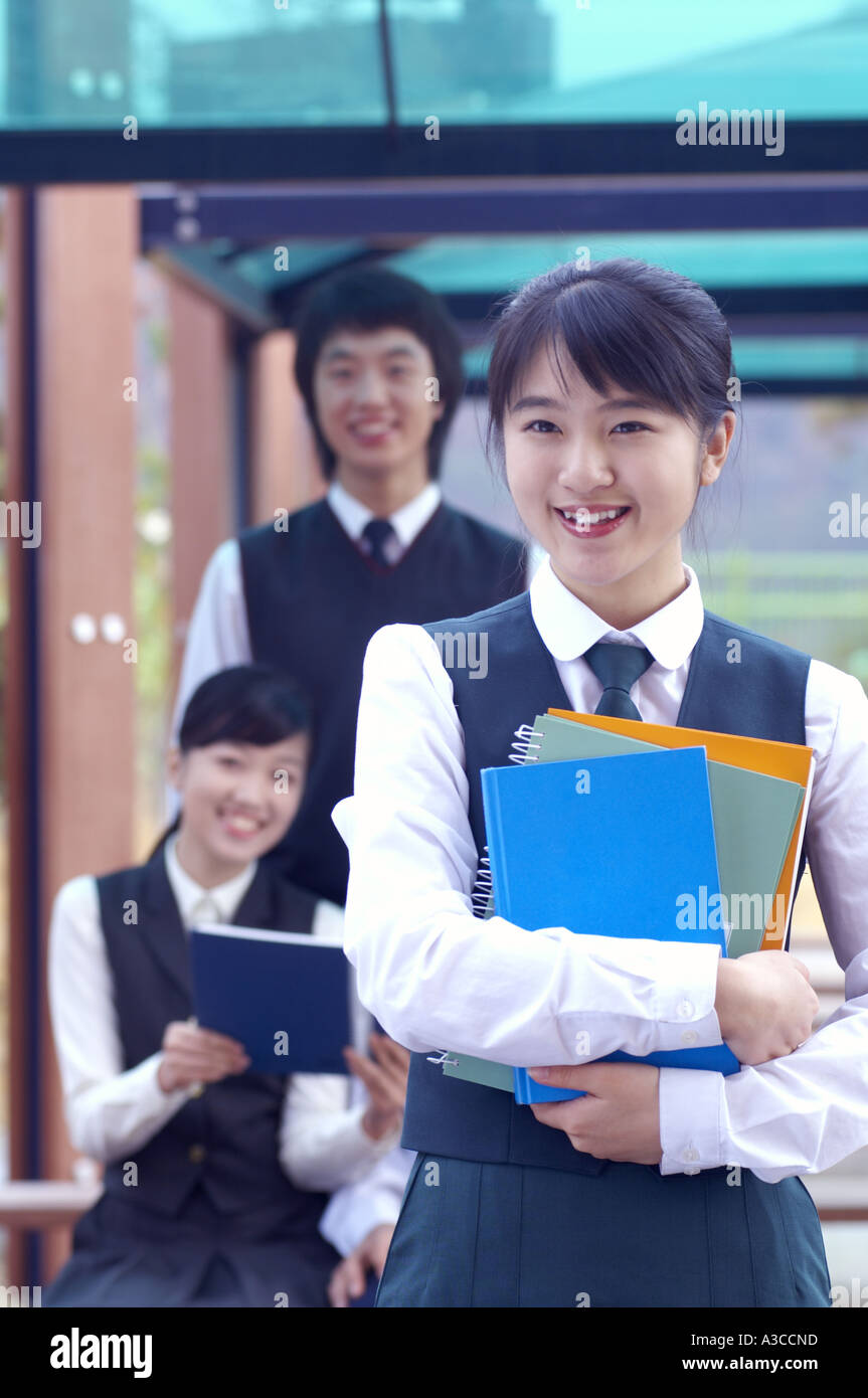 three teenagers in school uniforms Stock Photo - Alamy