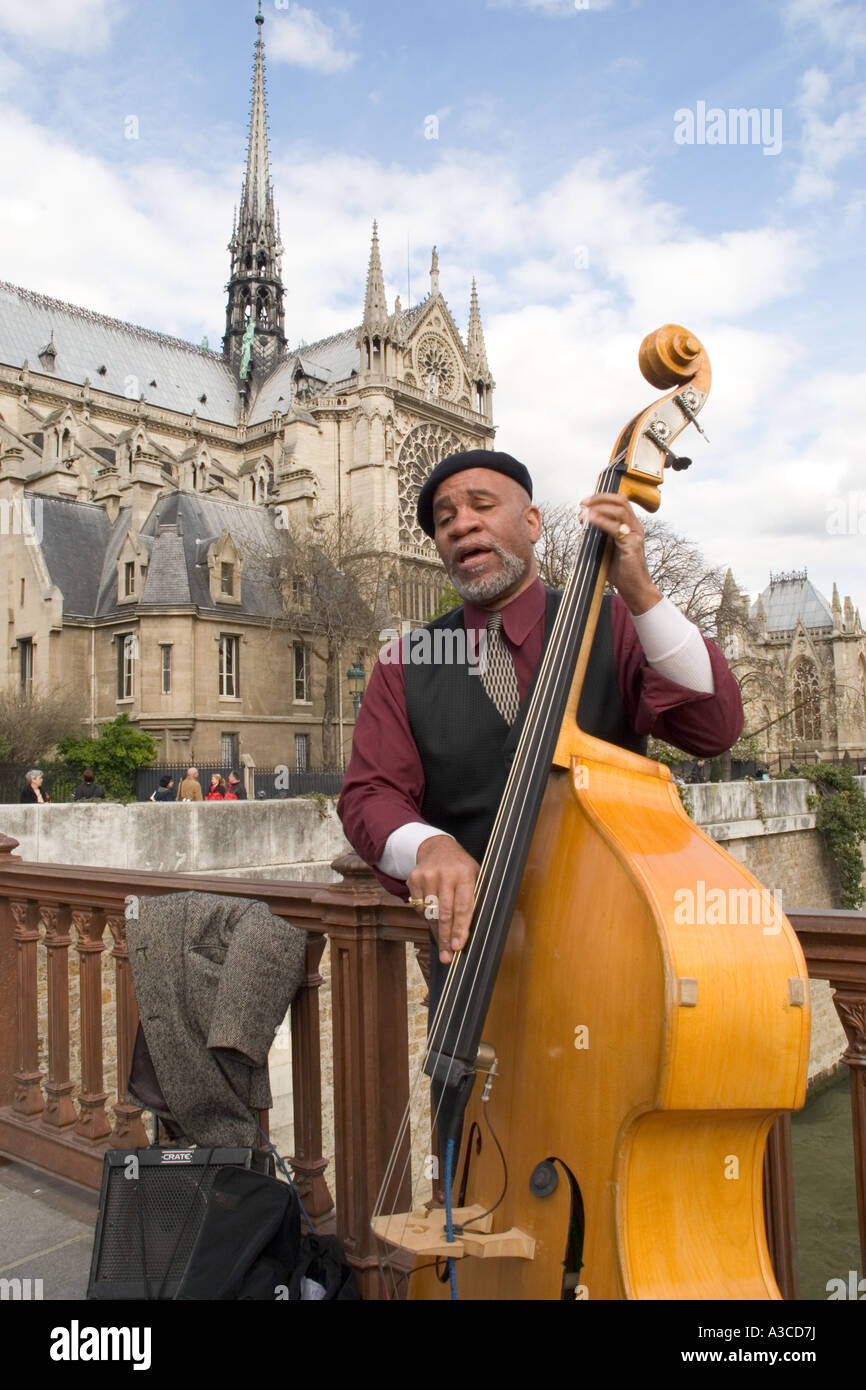 Man busking infront of the Notre Dame in Paris Stock Photo - Alamy