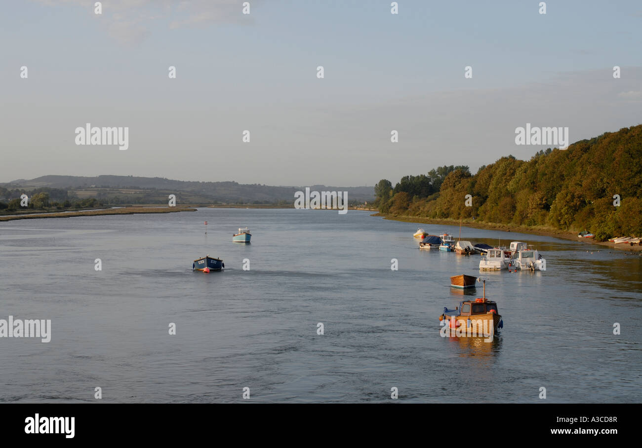 Small boats anchored in the River Axe on a fine evening Axmouth Devon ...