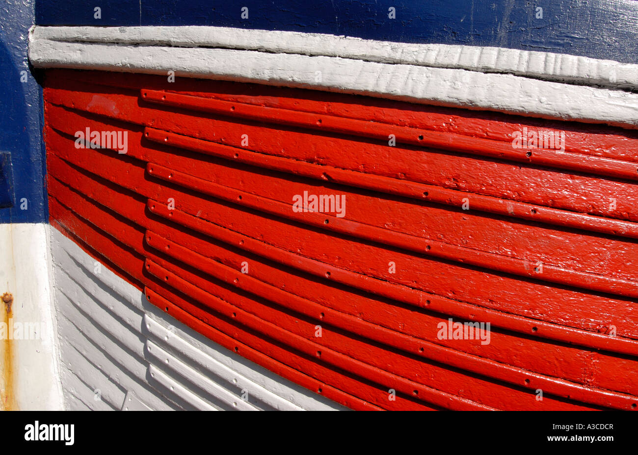 Retired old fashioned traditional clinker built fishing boat brightly ...