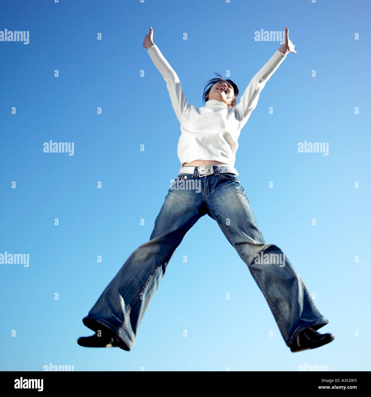 A teenage girl jumping in the air Stock Photo - Alamy
