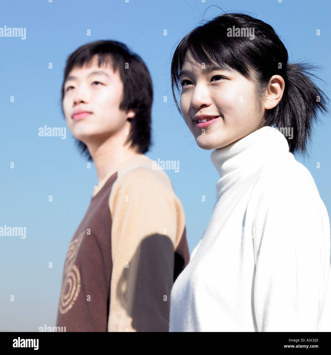 Two teens looking at same direction Stock Photo - Alamy