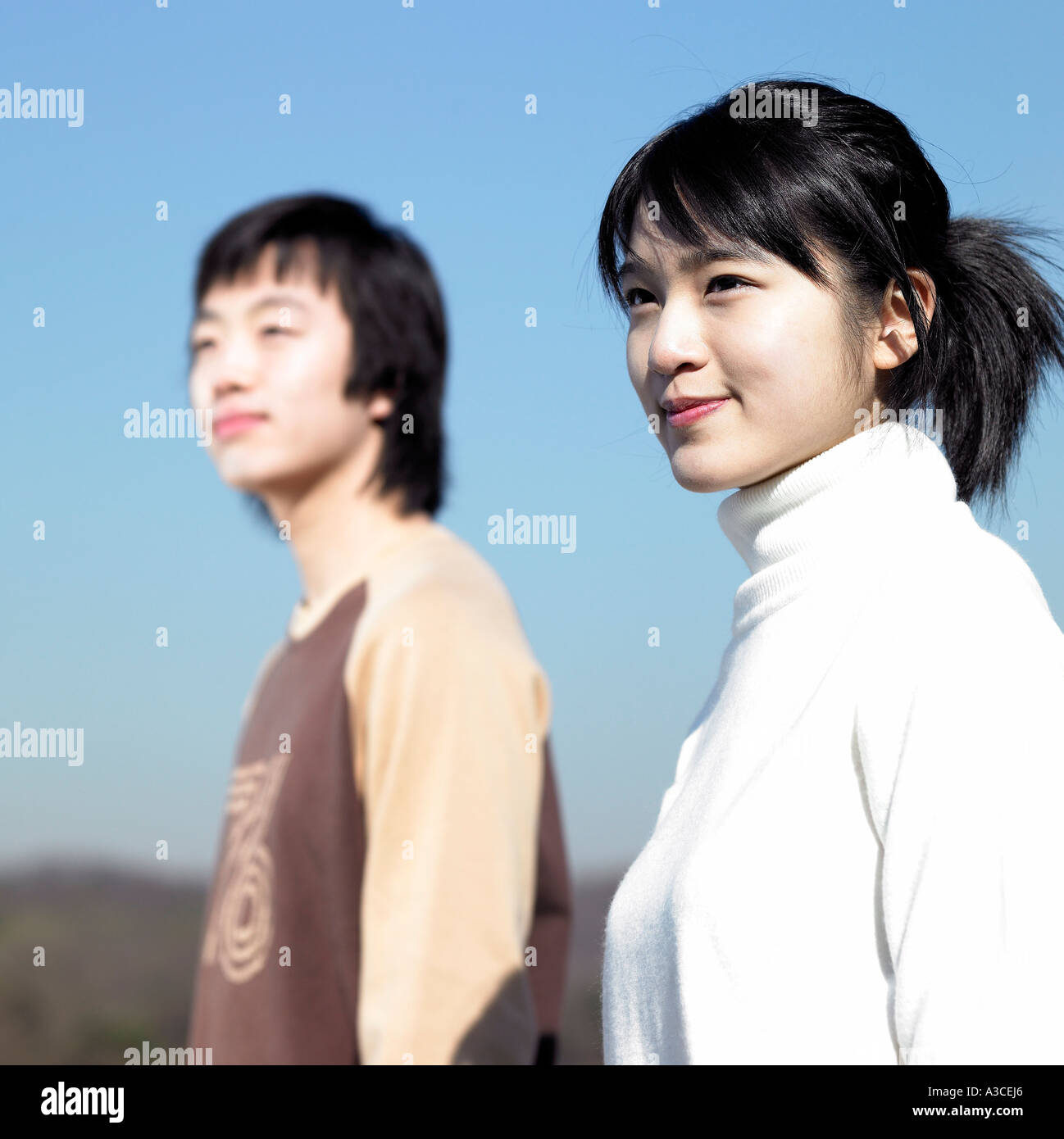 Two teens looking at same direction Stock Photo - Alamy