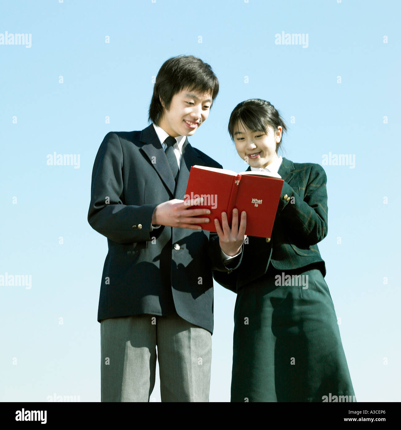 Students reading a book Stock Photo - Alamy