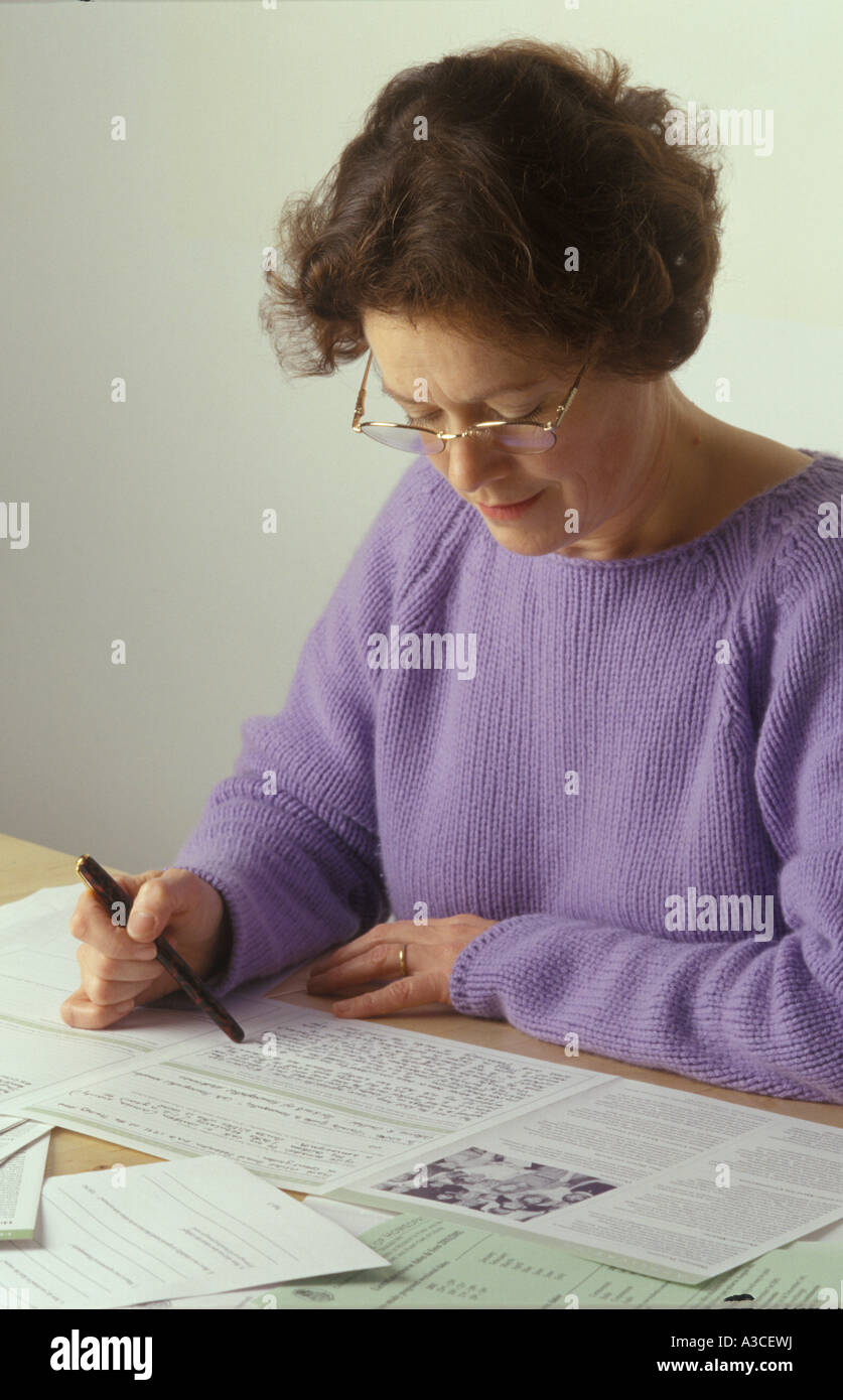 woman reading an application form Stock Photo - Alamy