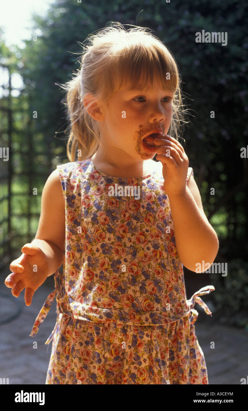 little girl eating chocolate with a smeared face Stock Photo - Alamy