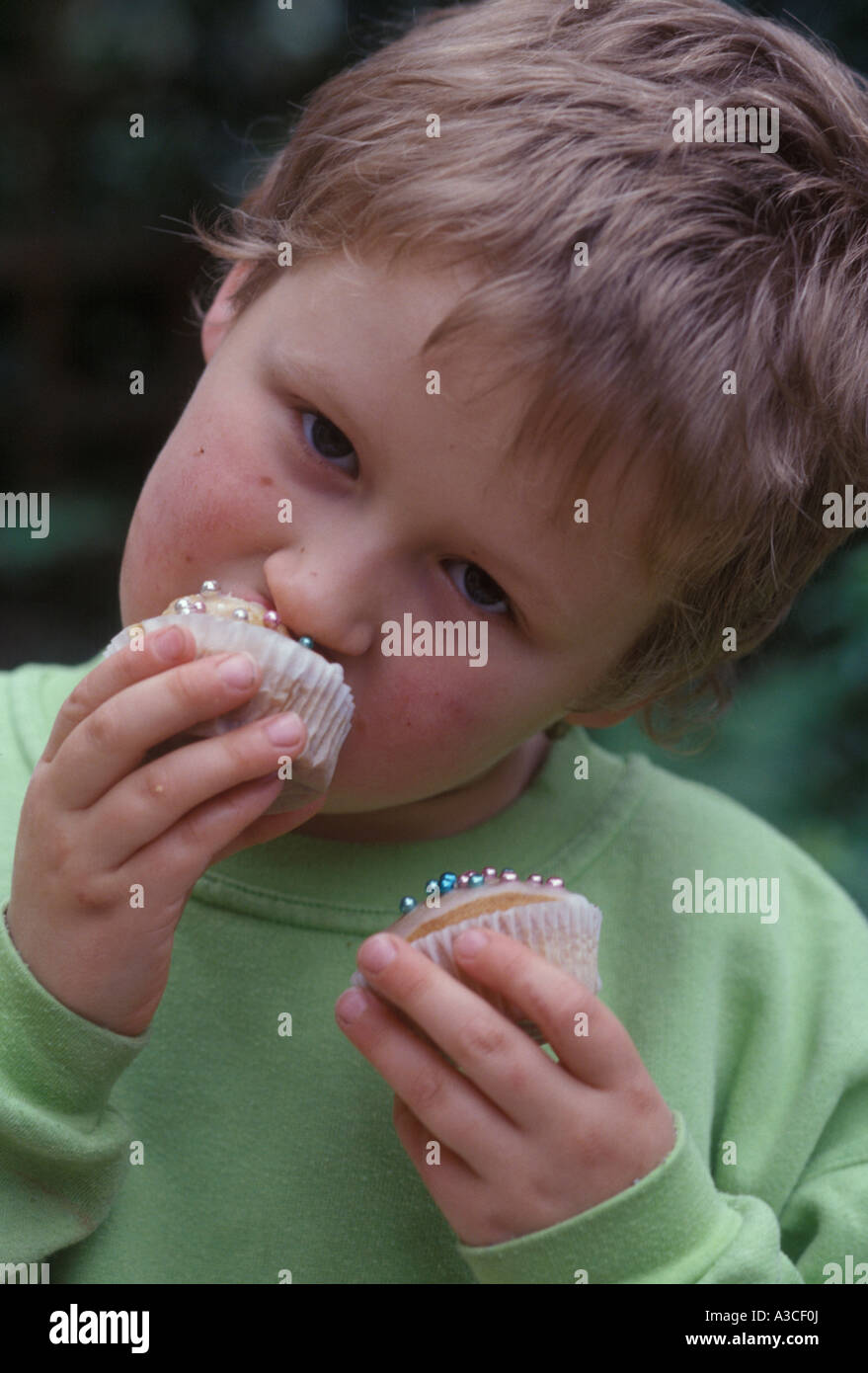 boy eating fairy cakes Stock Photo - Alamy