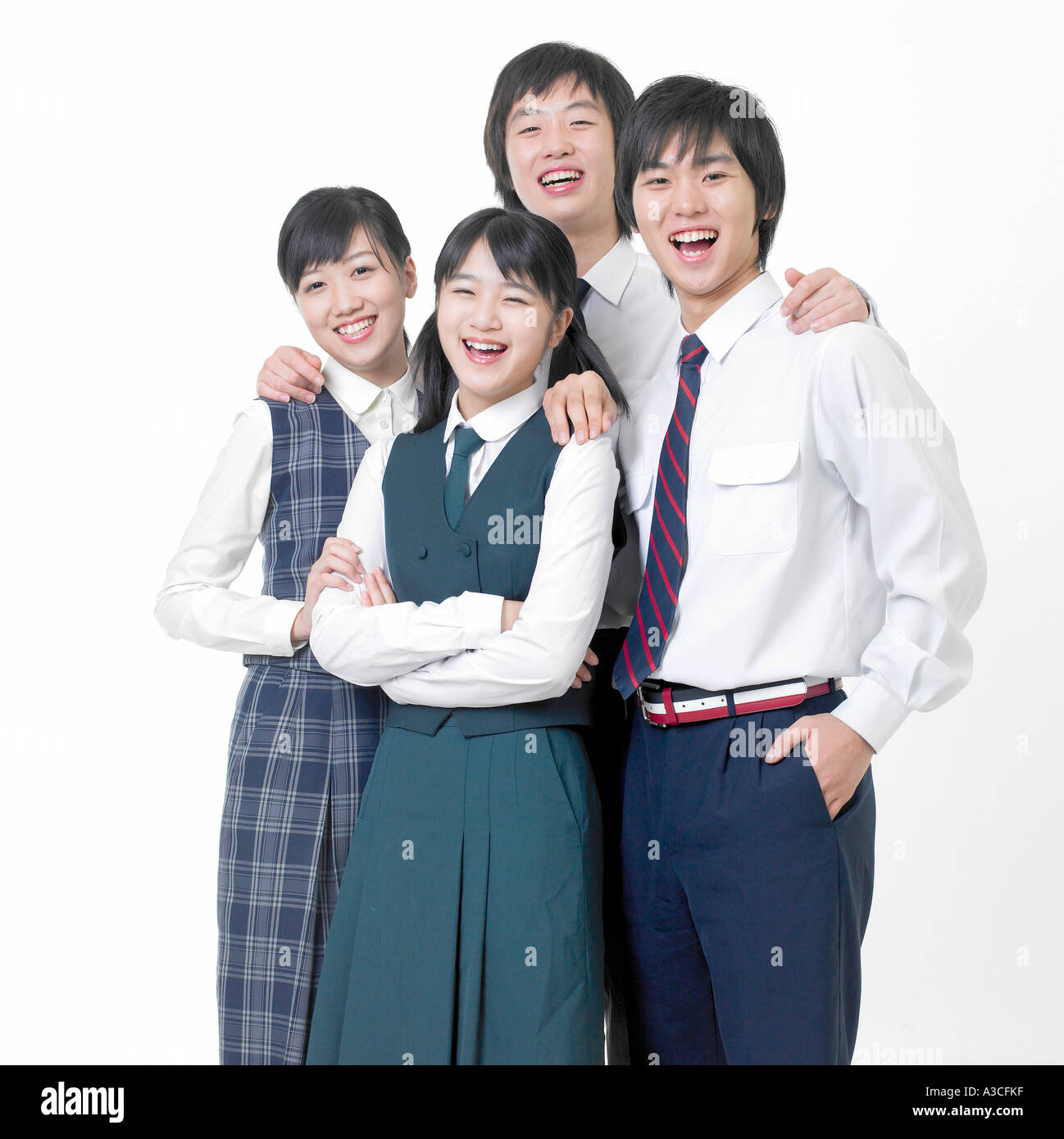 Four students gathered and smiled Stock Photo - Alamy