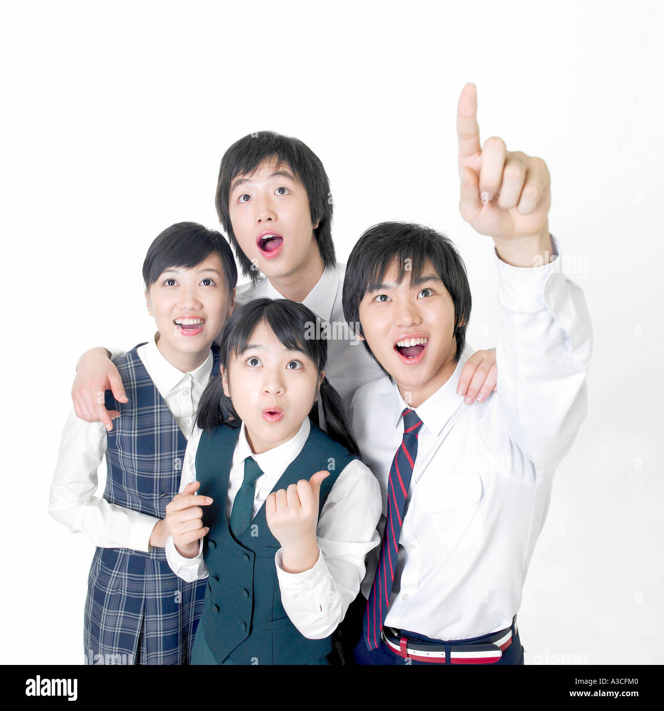 Four students gathered and one of them is pointing at the sky Stock ...